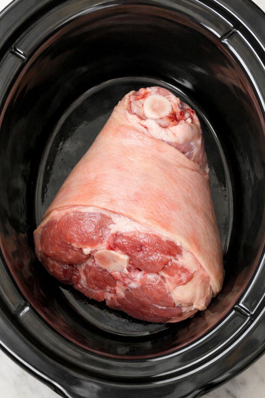 Put a whole raw ham hock in the slow cooker with 2 other basic items to ...