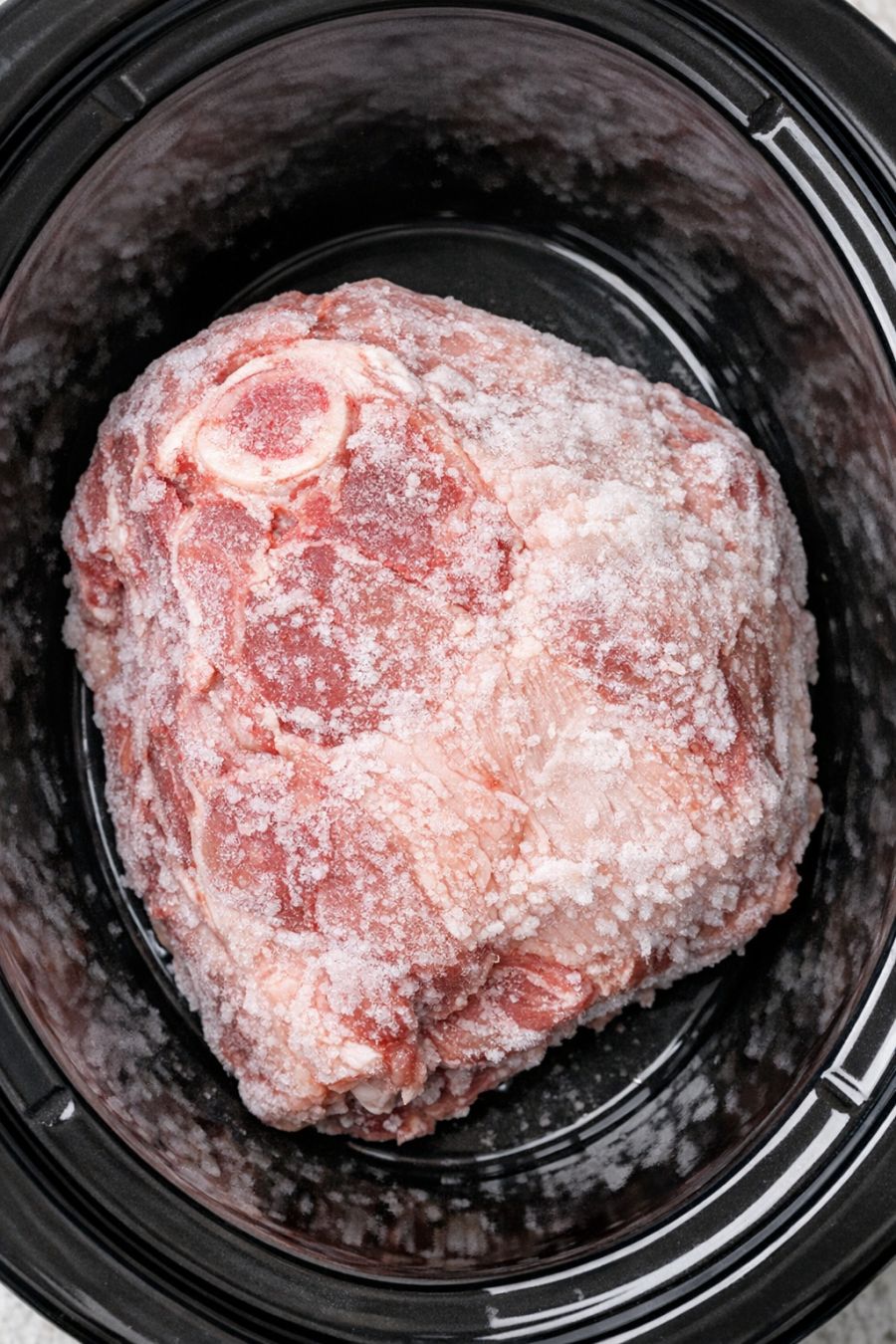 Dump a frozen bone-in pork shoulder roast in the slow cooker with 2 ...